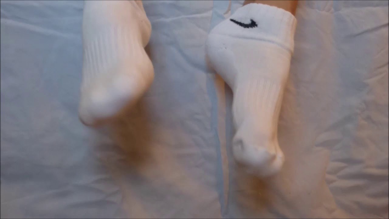 Guy feet after a hot day in nike socks and sneakers