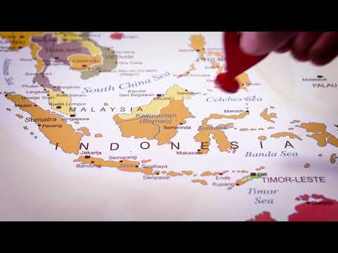 A person is placing 3d printing location GPS icon on map of Indonesia Travel Visit and Discover Indo