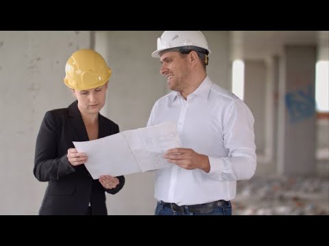 Architects Discuss Blueprint Stock Video