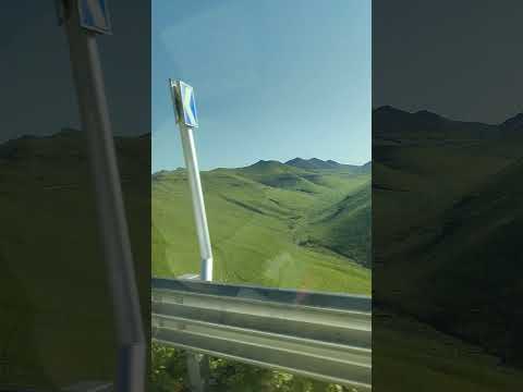 The mountains in the distance are undulating and uneven, with many hills.