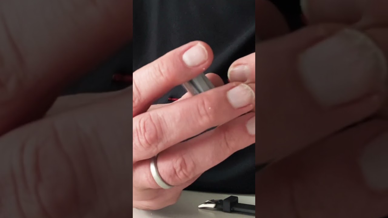 Removing the watch strap pin from an Omega moon Swatch