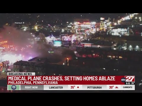 Medical plane crashes, setting homes ablaze