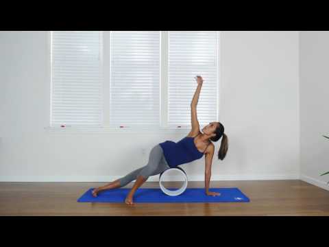 Side Plank Pose ( Vashistasana ) on a 321 STRONG Yoga Wheel