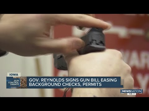 Iowa Gov. Kim Reynolds signs gun bill easing background checks, permits