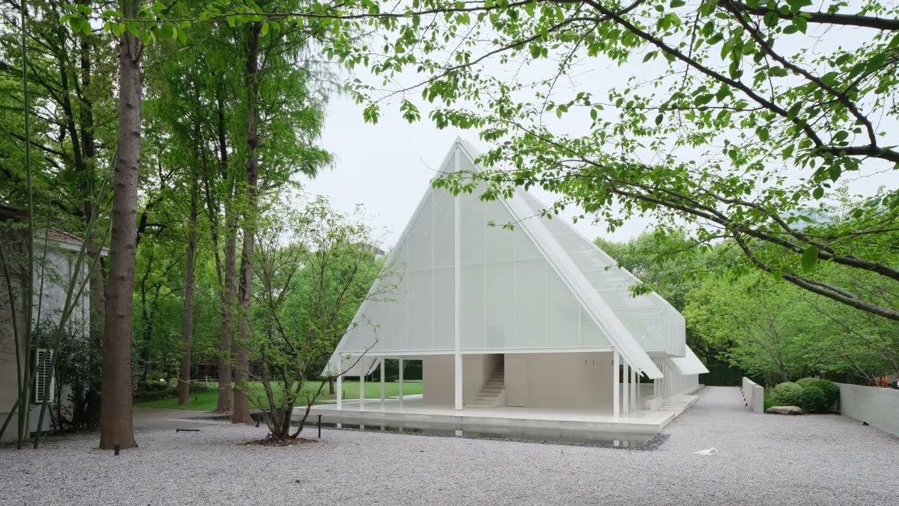 wing-like roof covers open gathering area by SHISUO in shanghai's memorial park