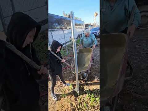 Two generations working together to mend fences
