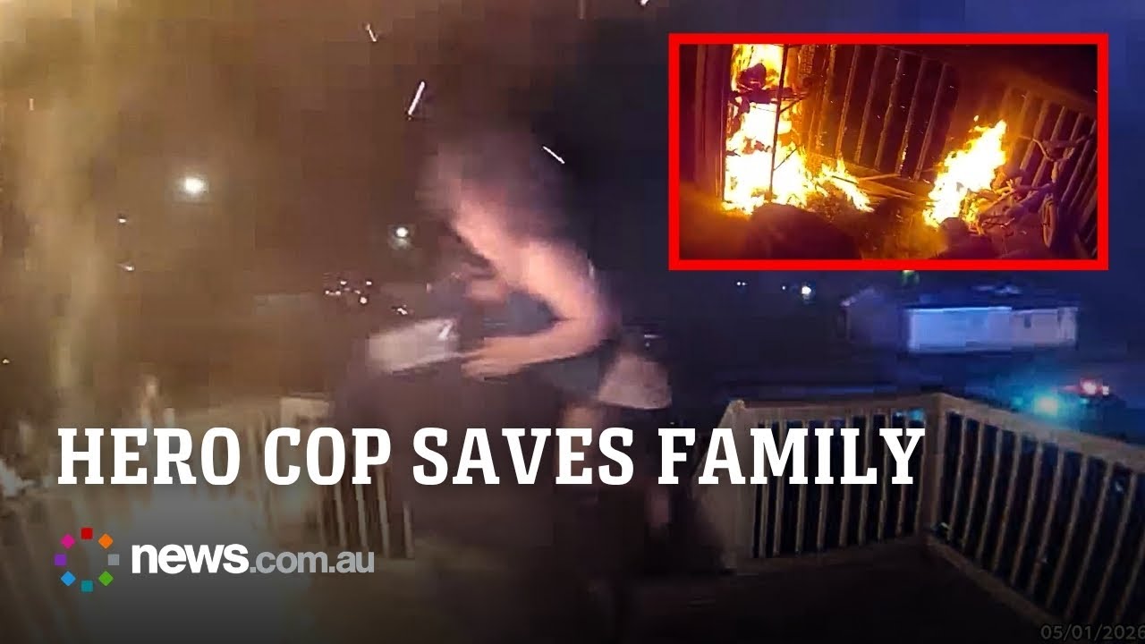 Officer busts down front door to save family from burning home