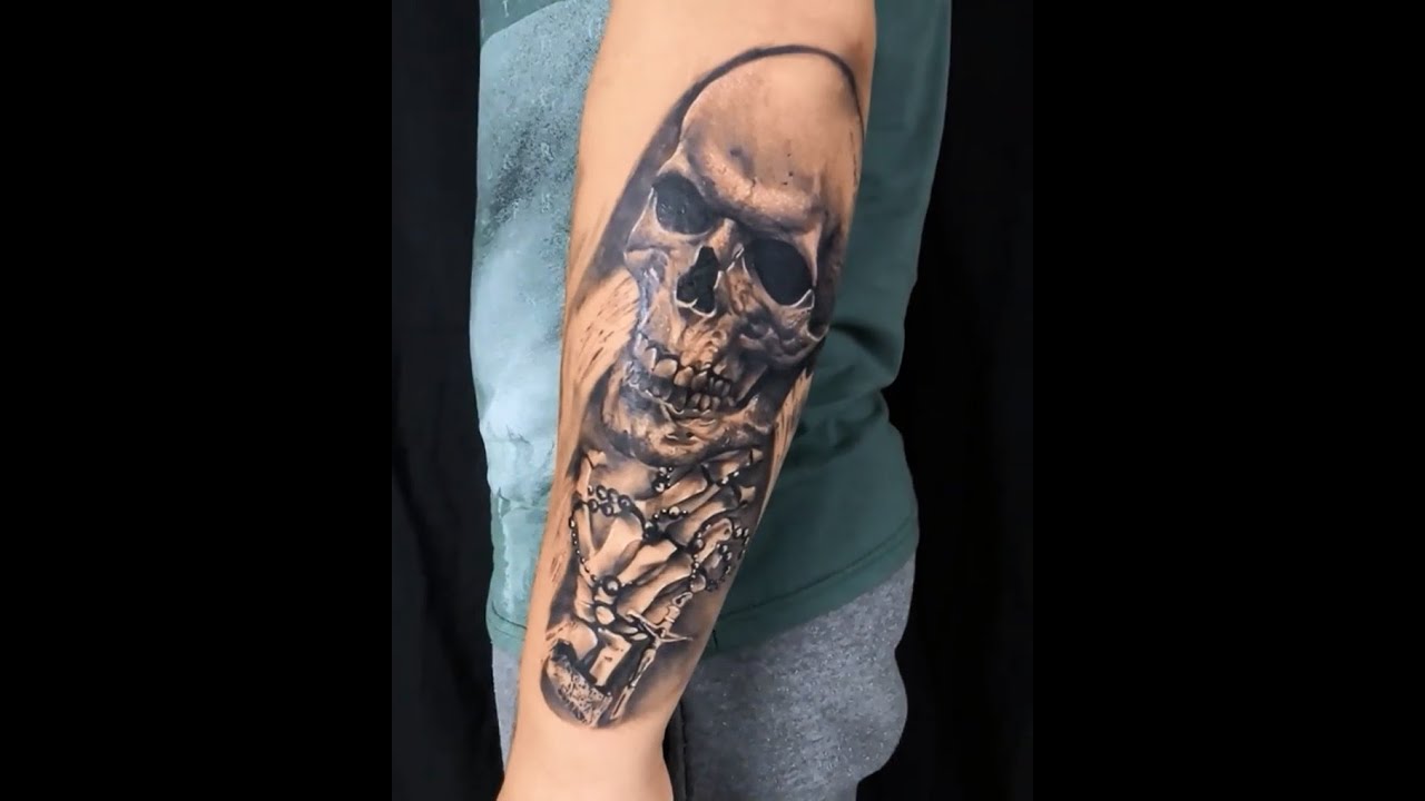 Tattoo of a skeleton's skull on a man's arm