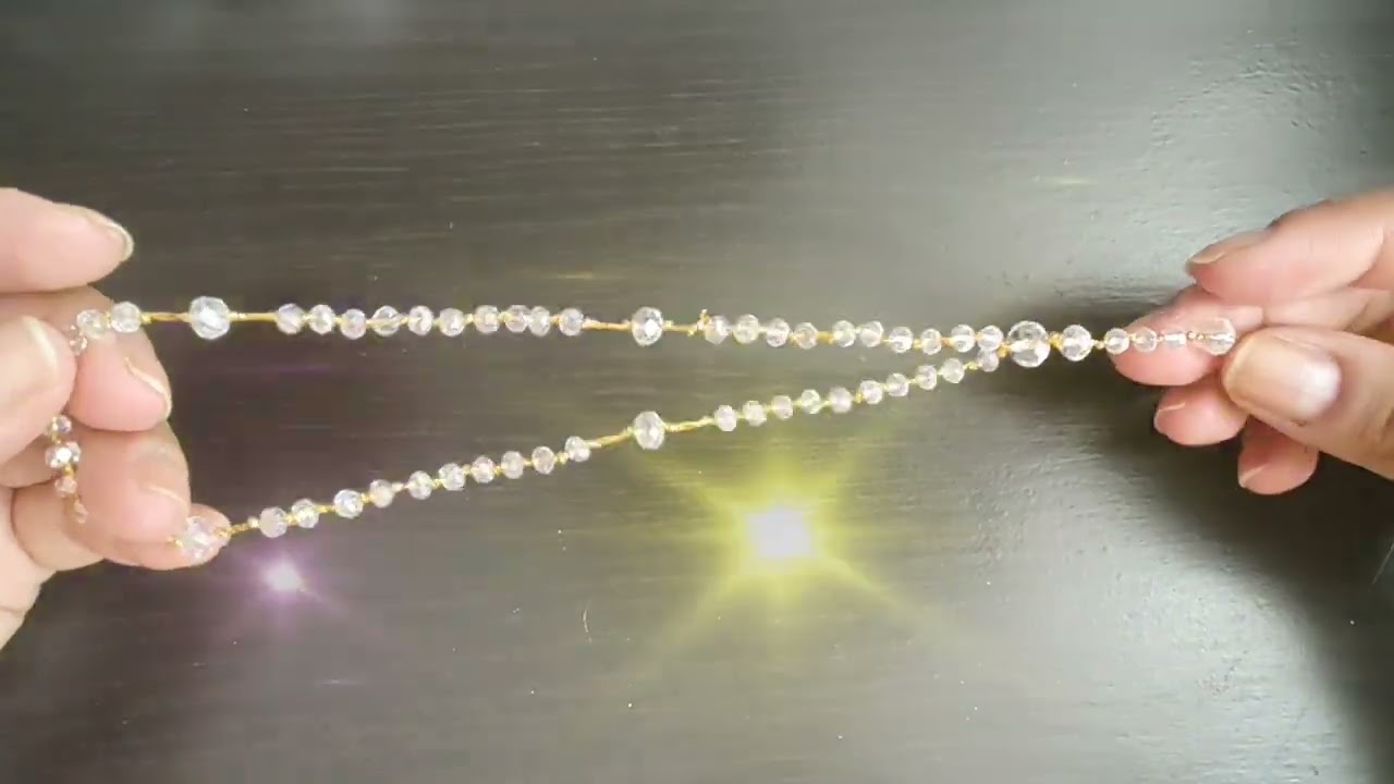 Rosario elaborado con cristal e hilo dorado