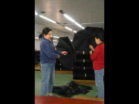 Worker stands and checks the umbrellas#little umbrella#factory #machine #umbrella #shorts