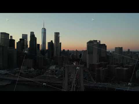 Aerial view of Brooklyn Bridge and heavy traffic on road. Flow on car lights. Silhouette of downtown