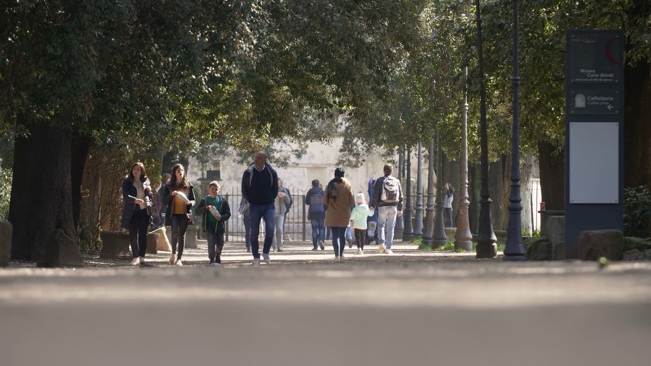 Family Walking In Park Villa Borghese