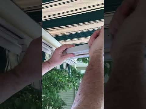 How do I change my wind sensor battery on my retractable awning?