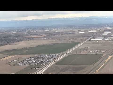 Cold April Denver, Colorado landing / arrival aerial views (Rockies, downtown Denver)