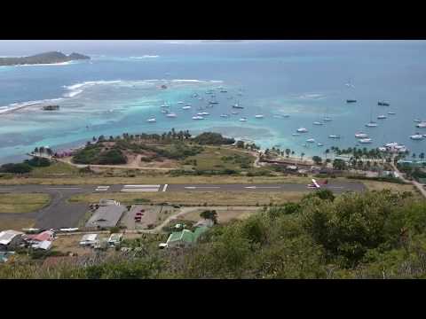 Turboprop airplane take-off, Union island Puerto Plata airport, Caribbean sea