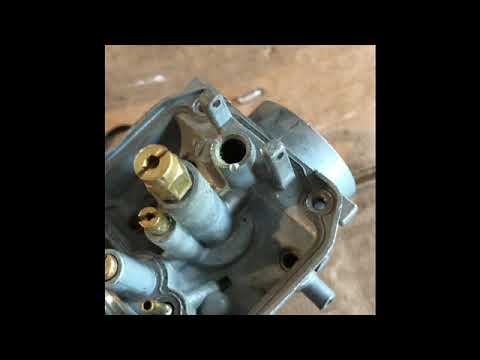 Removing the seat from a carburetor. Needle seat