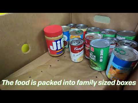 Food Bank volunteers pack boxes for COVID019 relief efforts