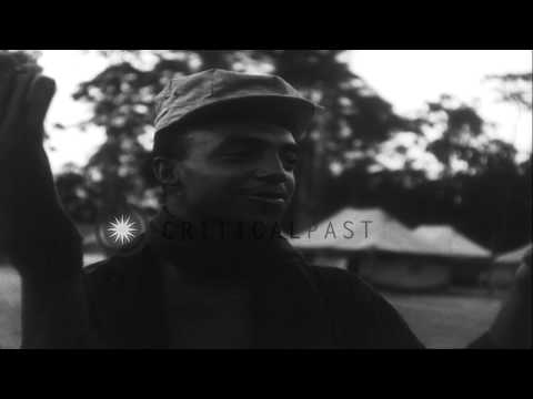 African American soldiers of 45th Engineer Regiment looking at pin-up picture of ...HD Stock Footage