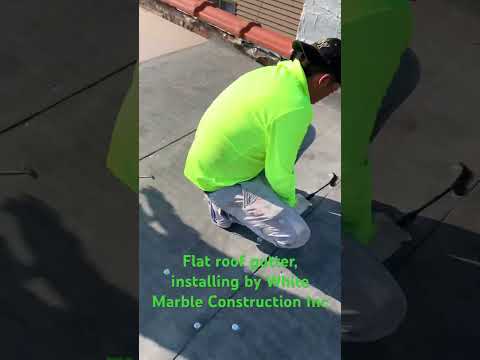 Flat roof gutter installing by White Marble Construction Inc 