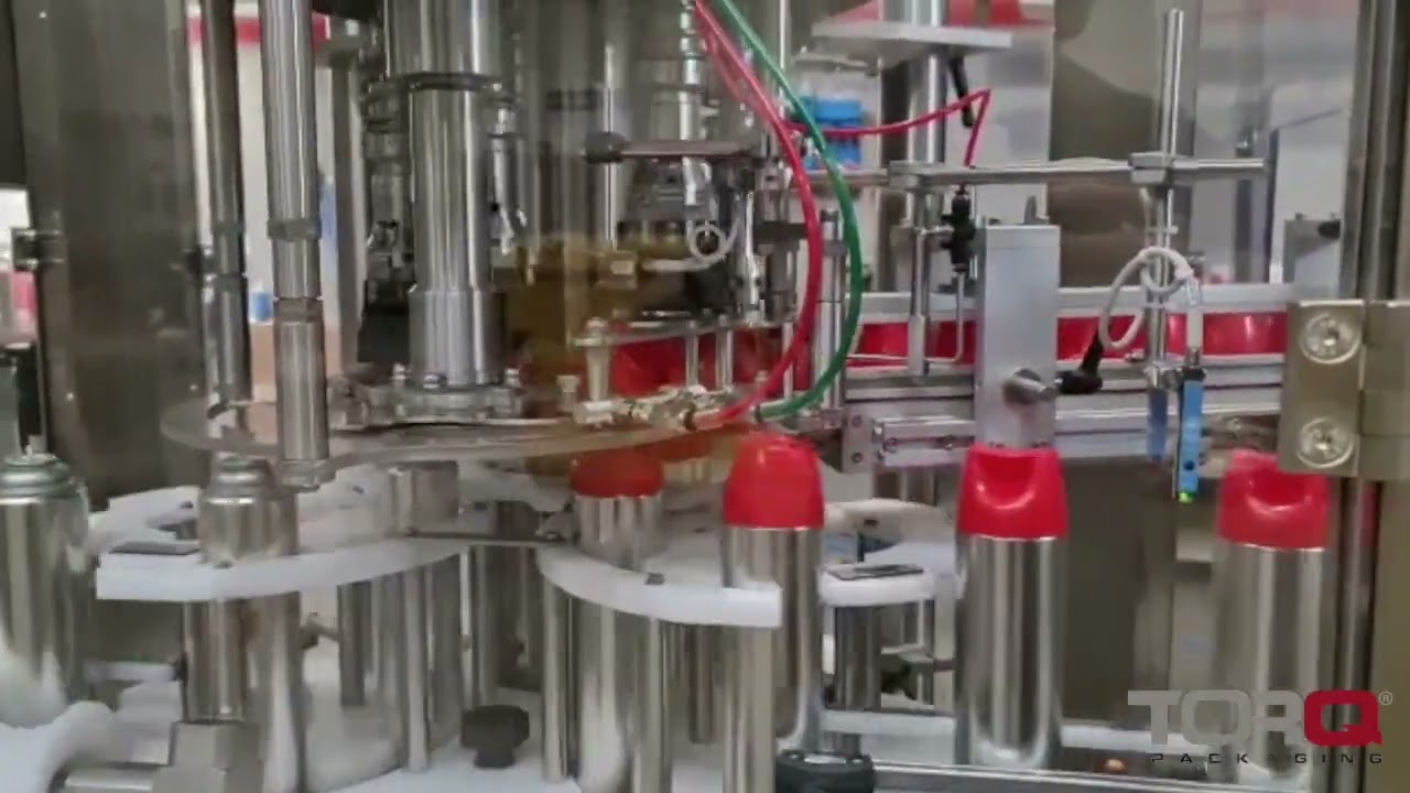 Machine for the Application of Actuator Caps on Aerosol Cans
