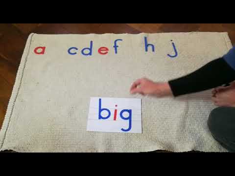 Building three letter phonetic words with the Montessori large movable alphabet