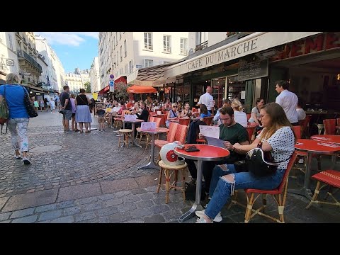 Rue Cler market street walking tour July 2022. famous street in Paris.