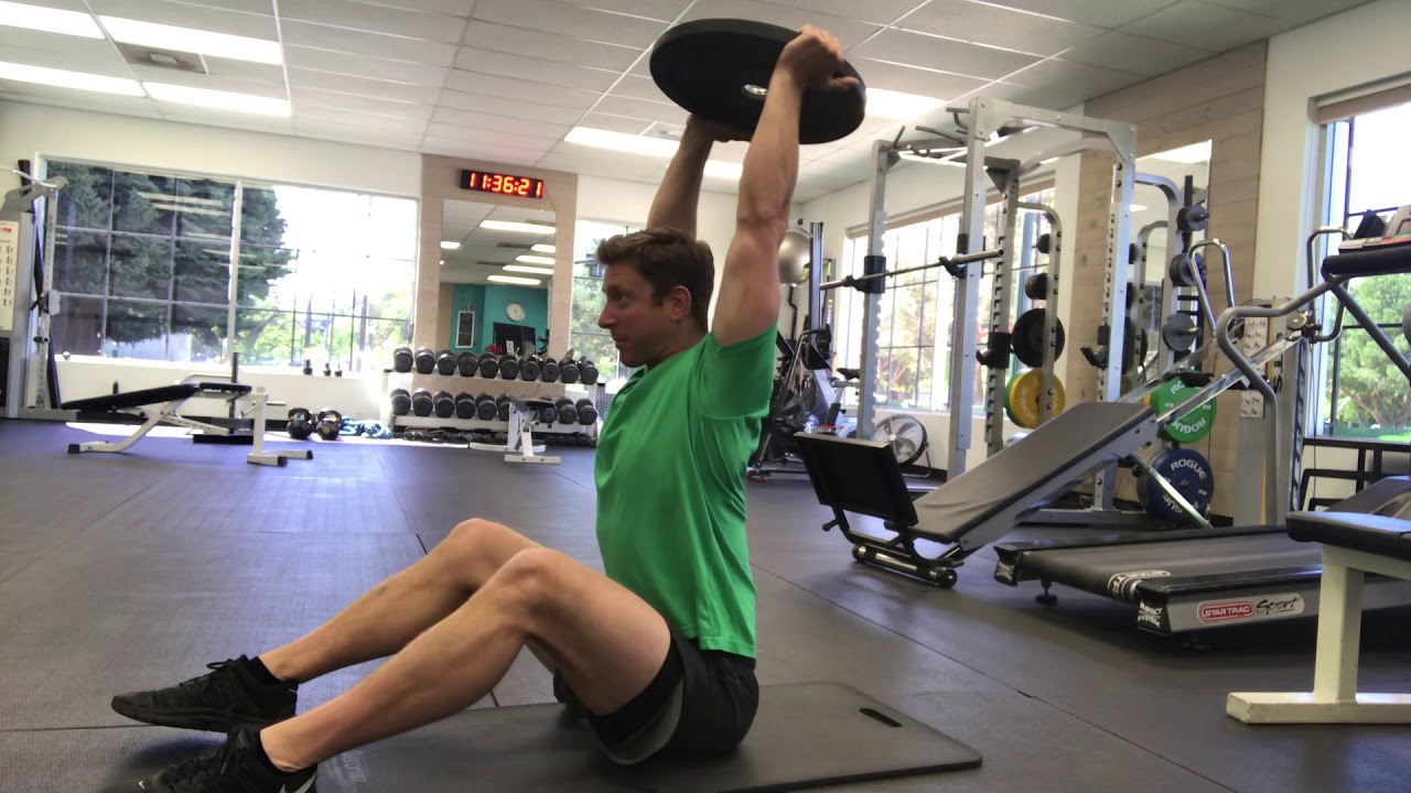 Plate Sit-up with overhead press exercise