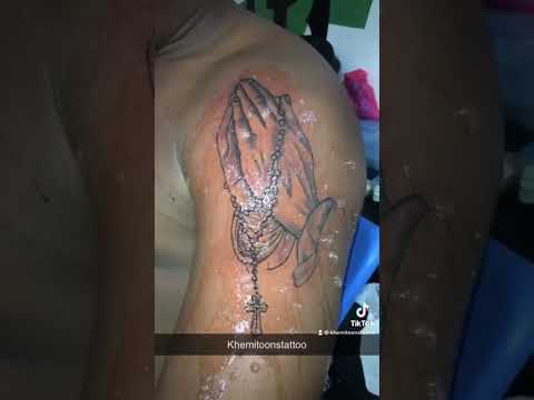 Praying hand tattoo