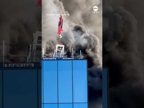 Man rescued from roof of burning high-rise by crane - ABC News