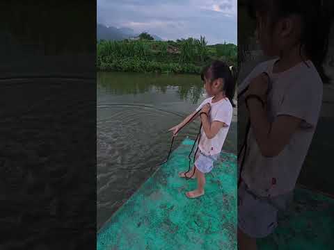 The correct way to cast a net Little girl casts a net to catch fish