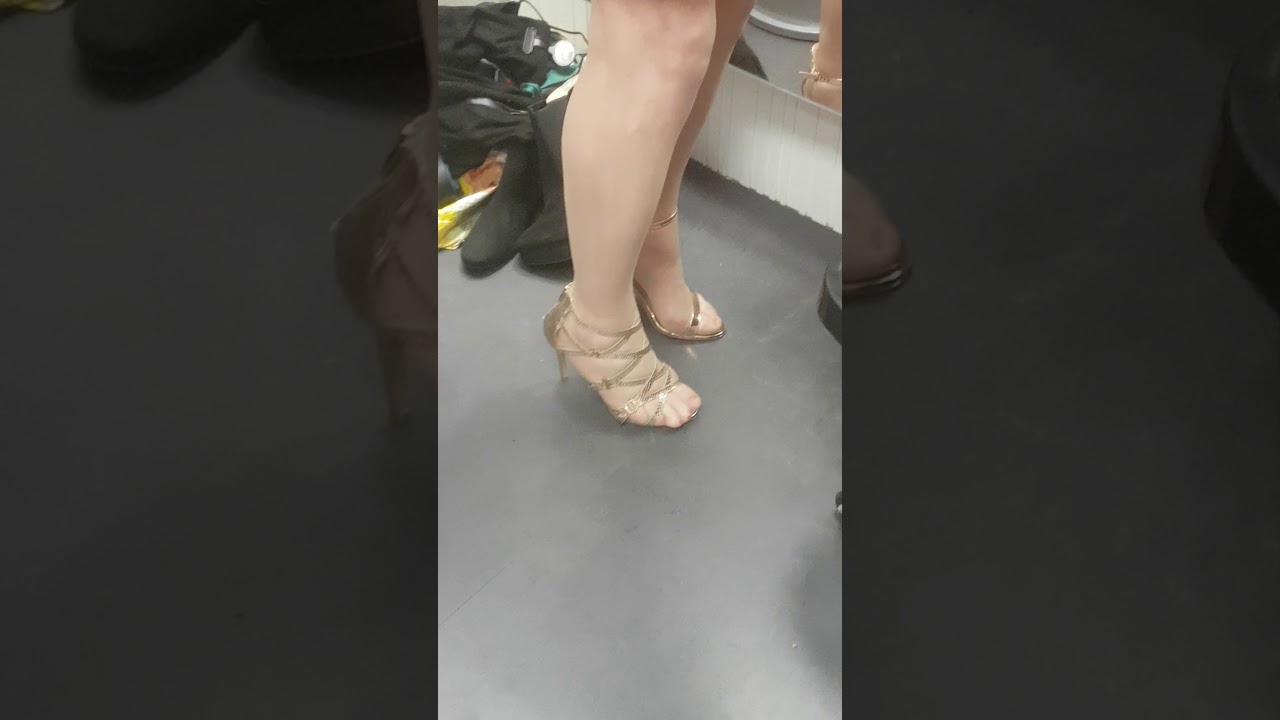 Tv in  gold high heels