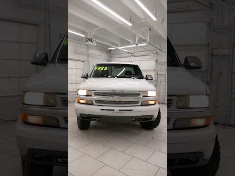 Our 1999 Silverado, standing tall with a robust lift and aggressive off-road tires.