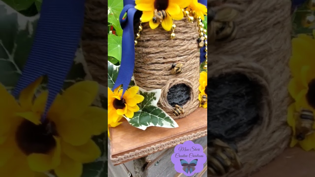 A honey bee Skep I made from a plastic flower pot, jute rope, silk flowers and ribbon