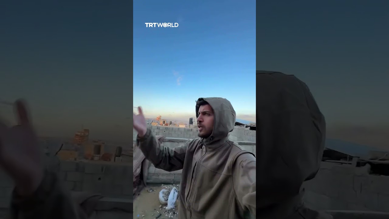 A Palestinian captures the devastation of an Israeli air strike in Gaza