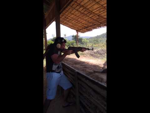 Damo shooting an AK47 in Cambodia
