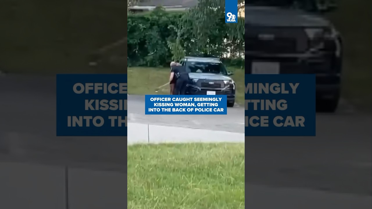 Officer caught seemingly kissing woman, getting into back of police car