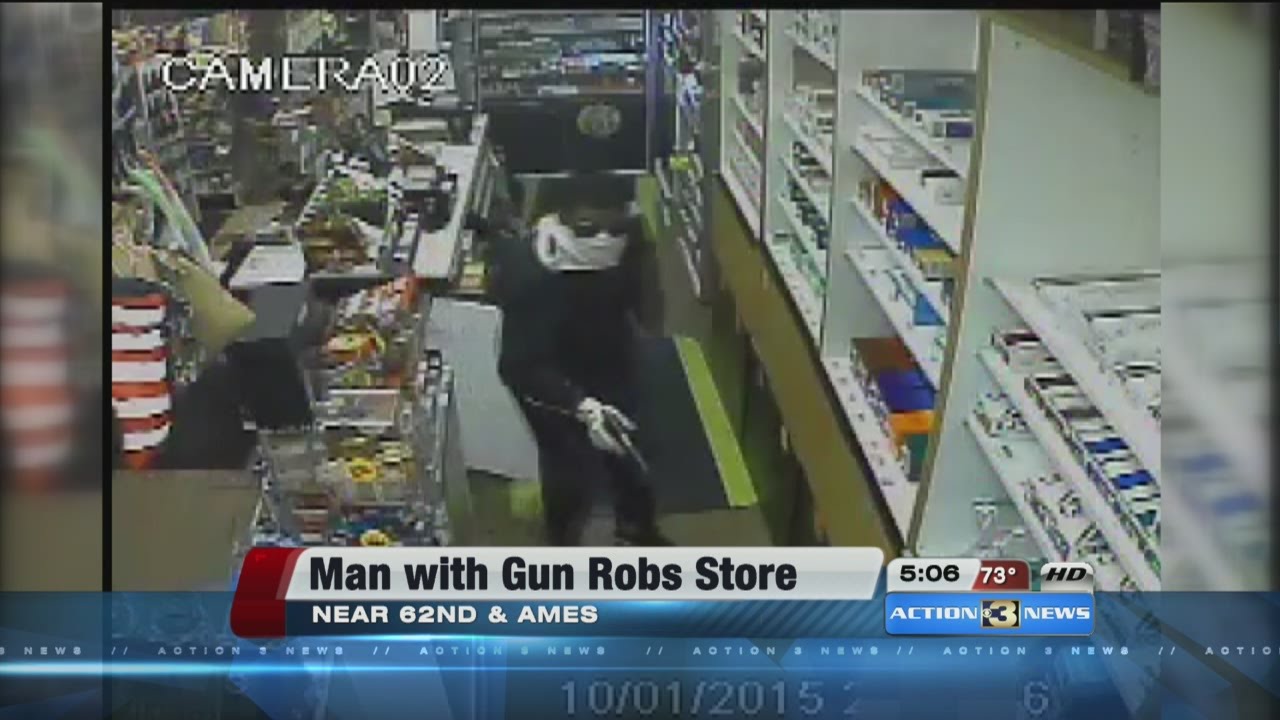 Surveillance video shows man rob convenience store at gunpoint