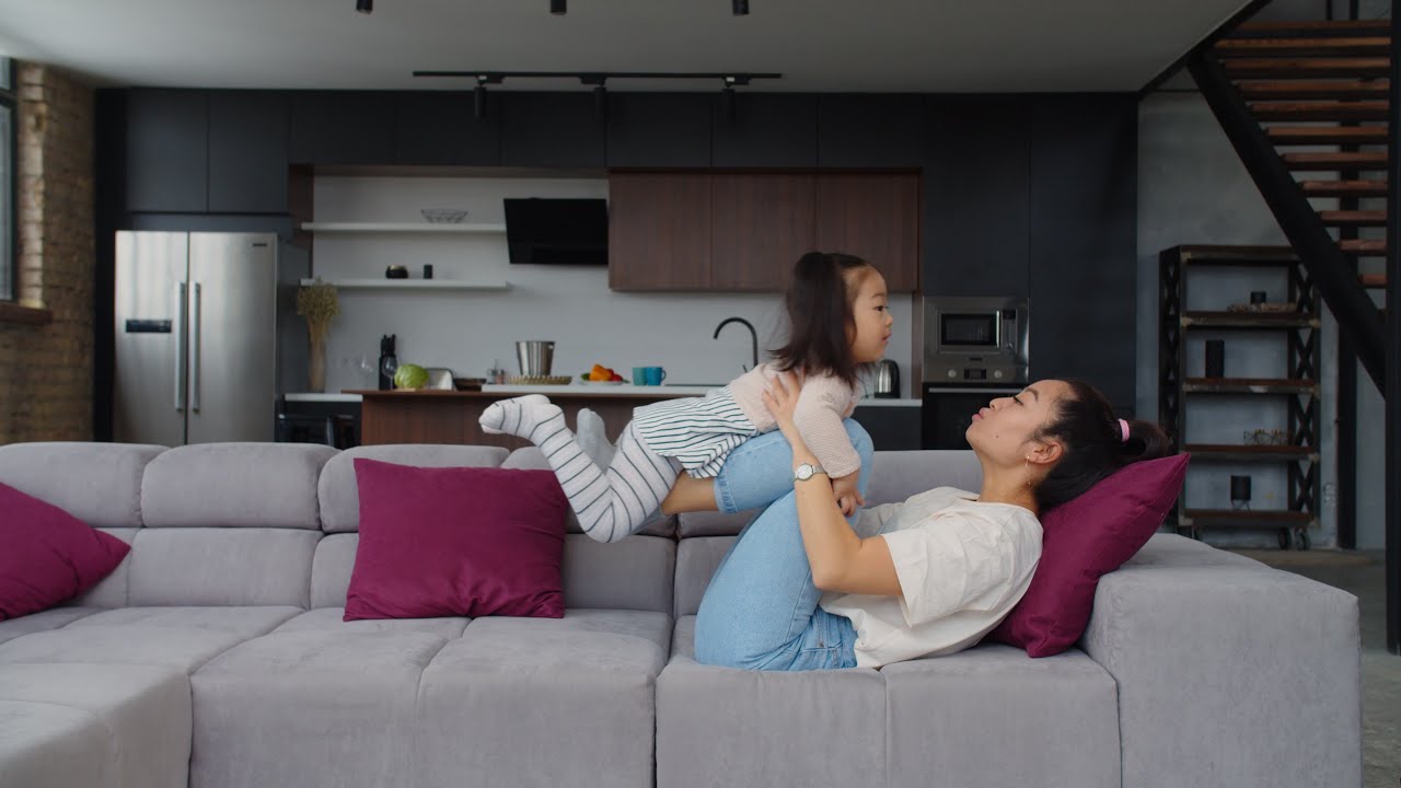 Happy asian mom and baby girl rejoicing leisure at home