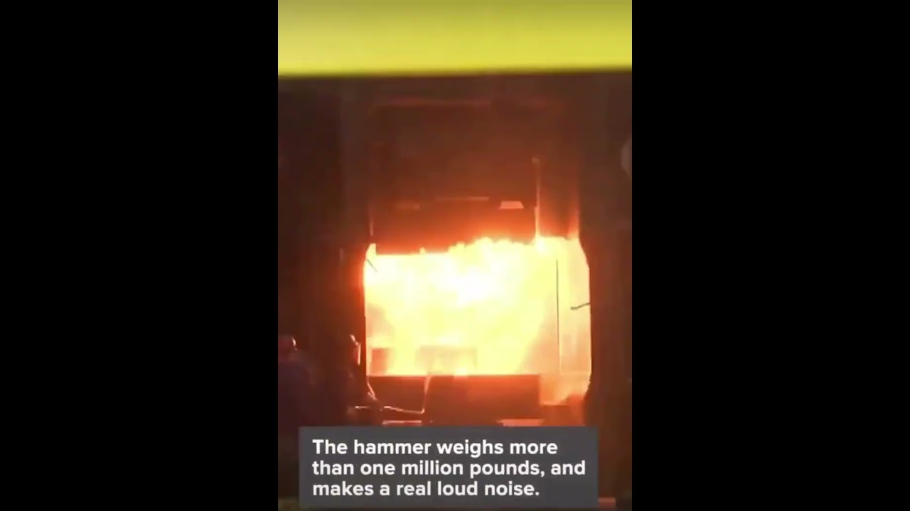 Workers using the 85 Hammer, a ten-story, million pound counterblow hammer in Wisconsin.