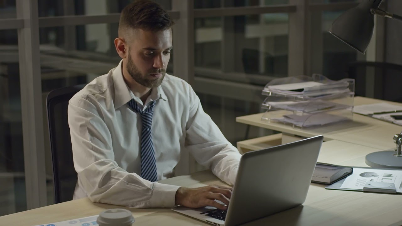 Businessman Focused on Work at His Laptop