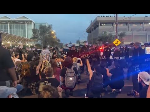 Police kneel with protesters in downtown Phoenix