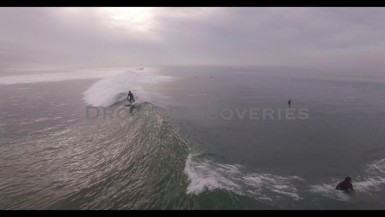 Surfing catching wave with sun reflection, Aerial, 4K, 16s, 32of133, Surfing, Beach, California coas