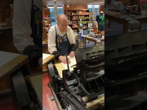 Howard tells a joke while letterpress printing.