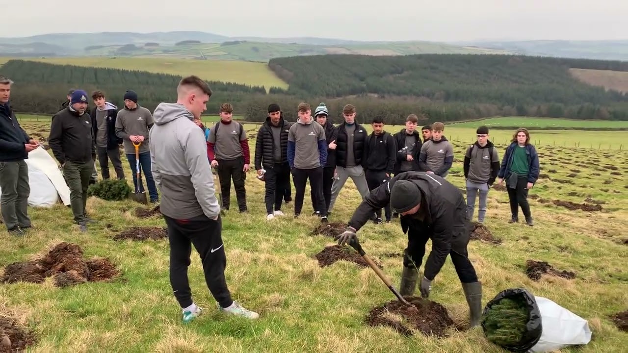 Professional forester, Pearse Gath, teaches students the best way to plant trees