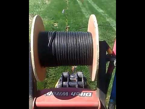 Vibratory plow burying fiber
