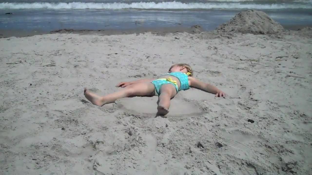 Grace making sand angels.....