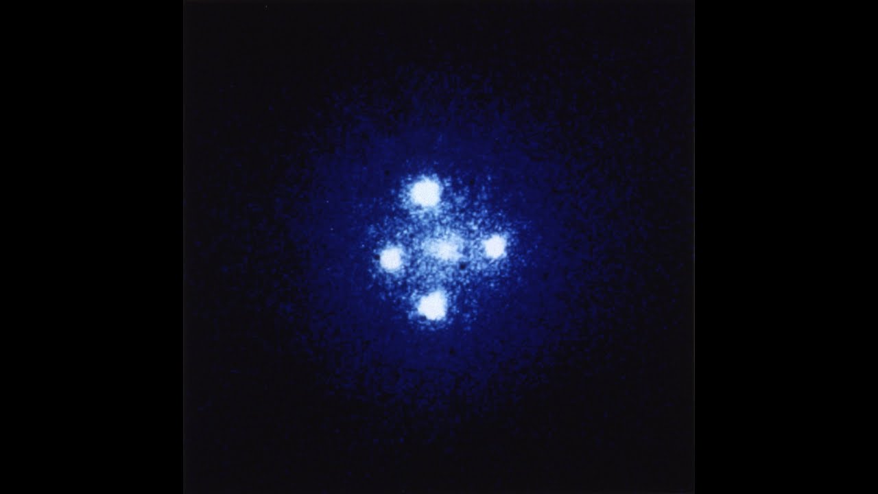 What is the Einstein Cross phenomenon in the cosmos?