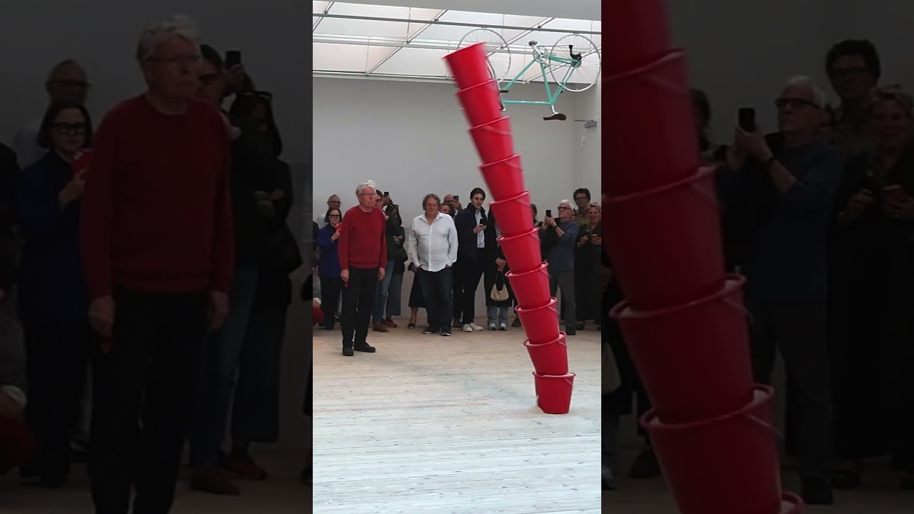 Artist Roman Signer activates his sand bucket sculpture at Malmö Konsthall