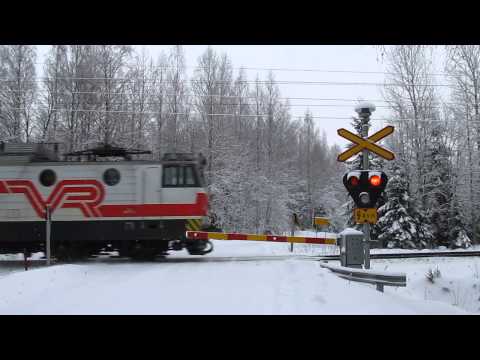 Freight train T 2240 passed NAAKKIMA (Km. 0362+0378) level crossing in Pieksämäki, Finland