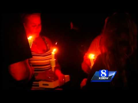 Mourners grieve the loss of 8-year-old Madyson Middleton at a candlelight vigil